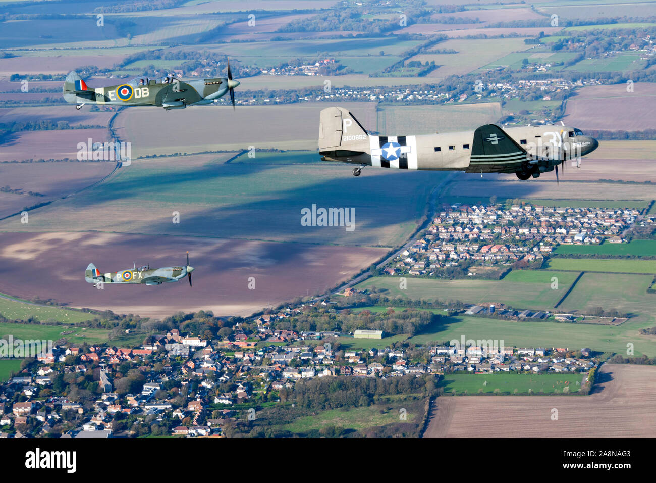 A World War II Dakota, with two Spitfires, drops three-quarters-of-a ...