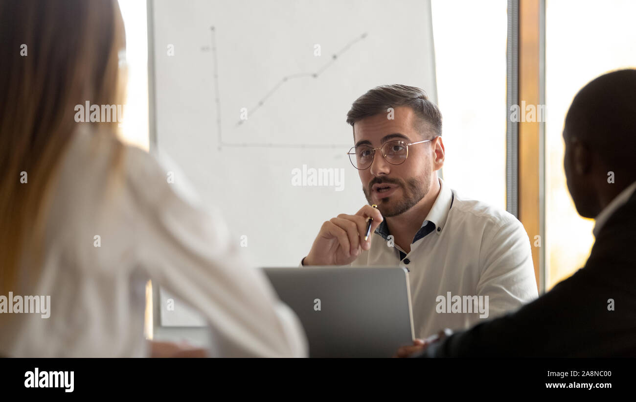 Concentrated male leader lead business meeting with employees Stock ...