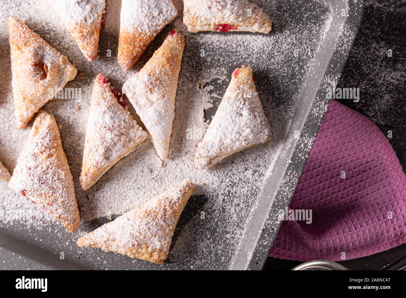 Baking tray with fresh pastry on the kitchen table Stock Photo - Alamy