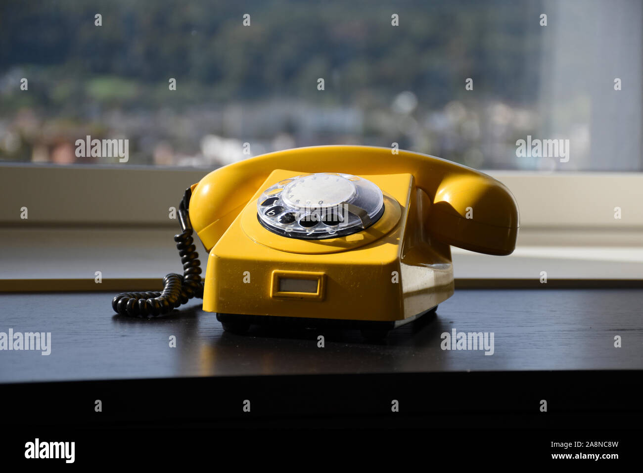 Old Retro Vintage Yellow Rotary Telephone on black wood table Stock ...