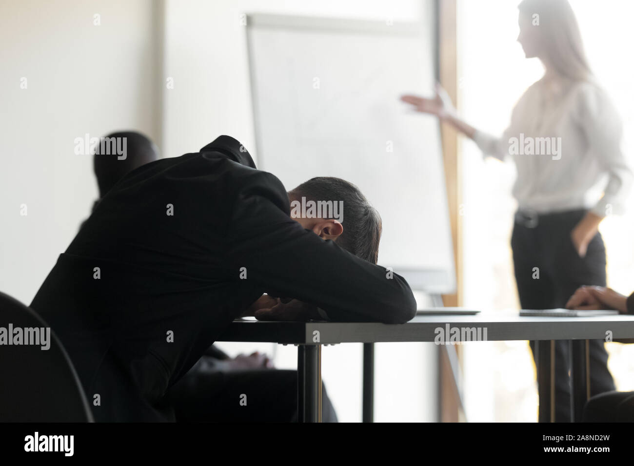 Tired male employee fall asleep at office meeting Stock Photo - Alamy
