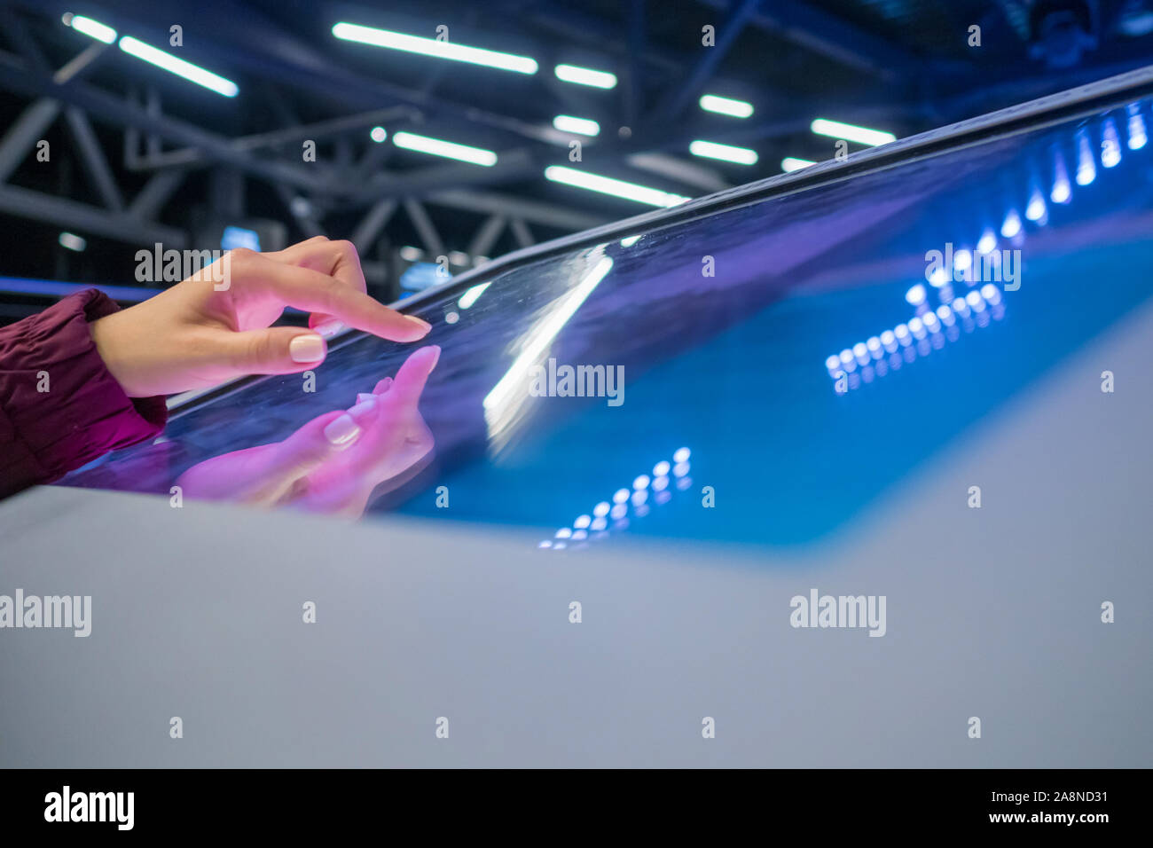 Woman using multimedia touchscreen display of interactive kiosk Stock ...