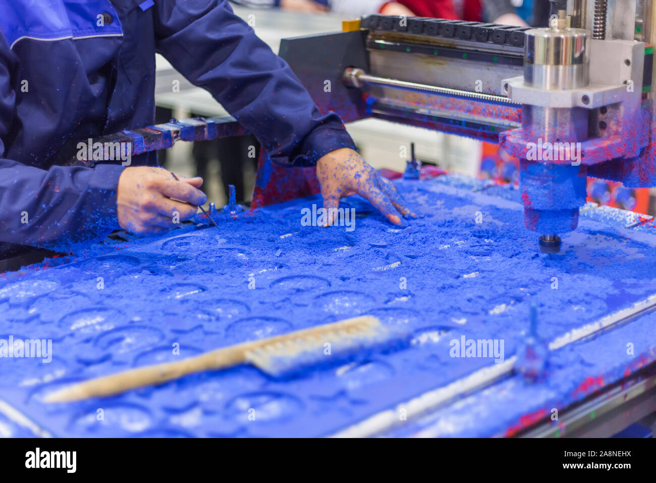 Milling machine during work with blue plastic material at technology ...