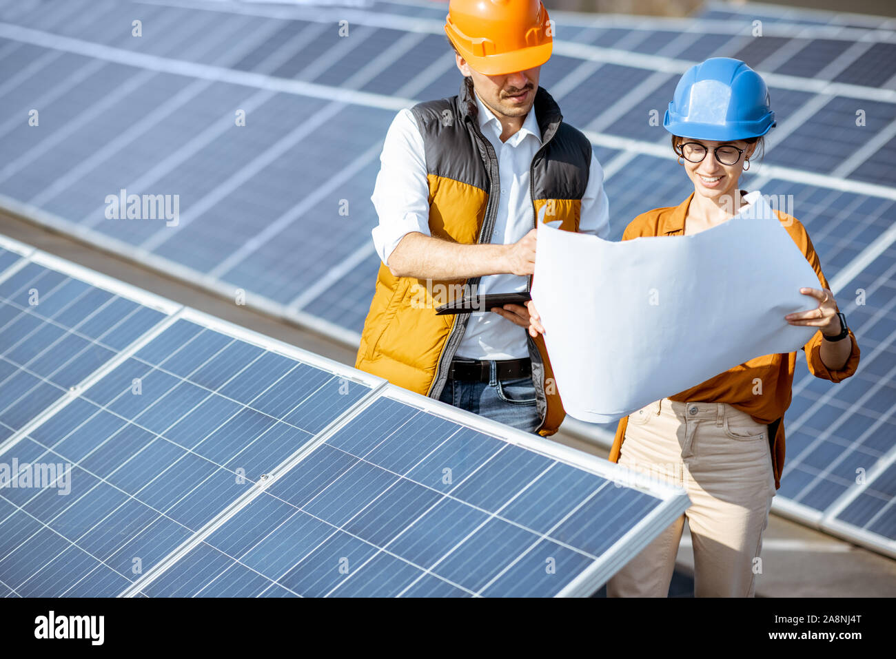 Two engineers or architects examining the construction of a solar power ...