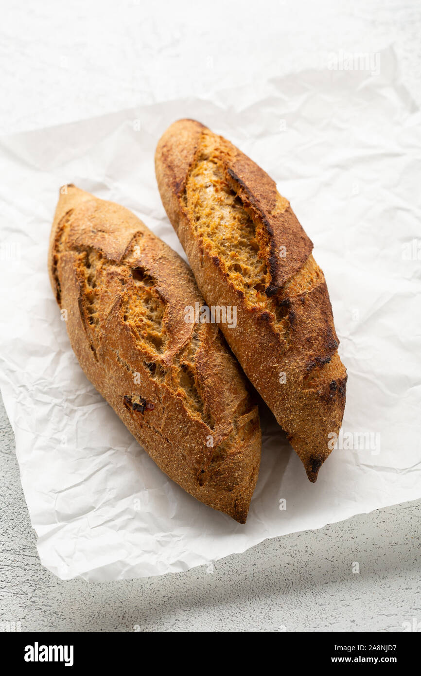 Two loaf of artisan bread top view on white background Stock Photo - Alamy