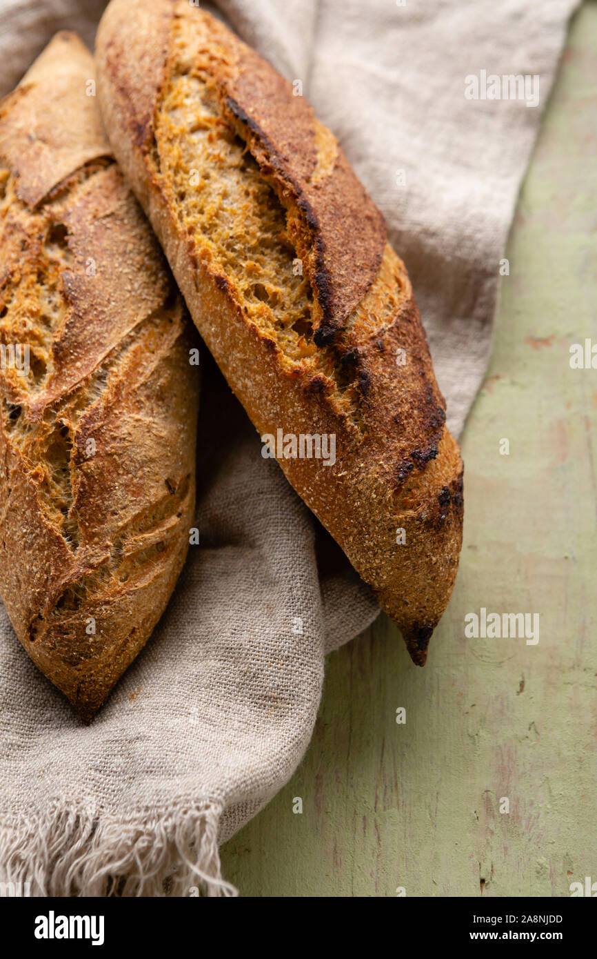 Loaf of artisan bread top view on rustic background Stock Photo - Alamy