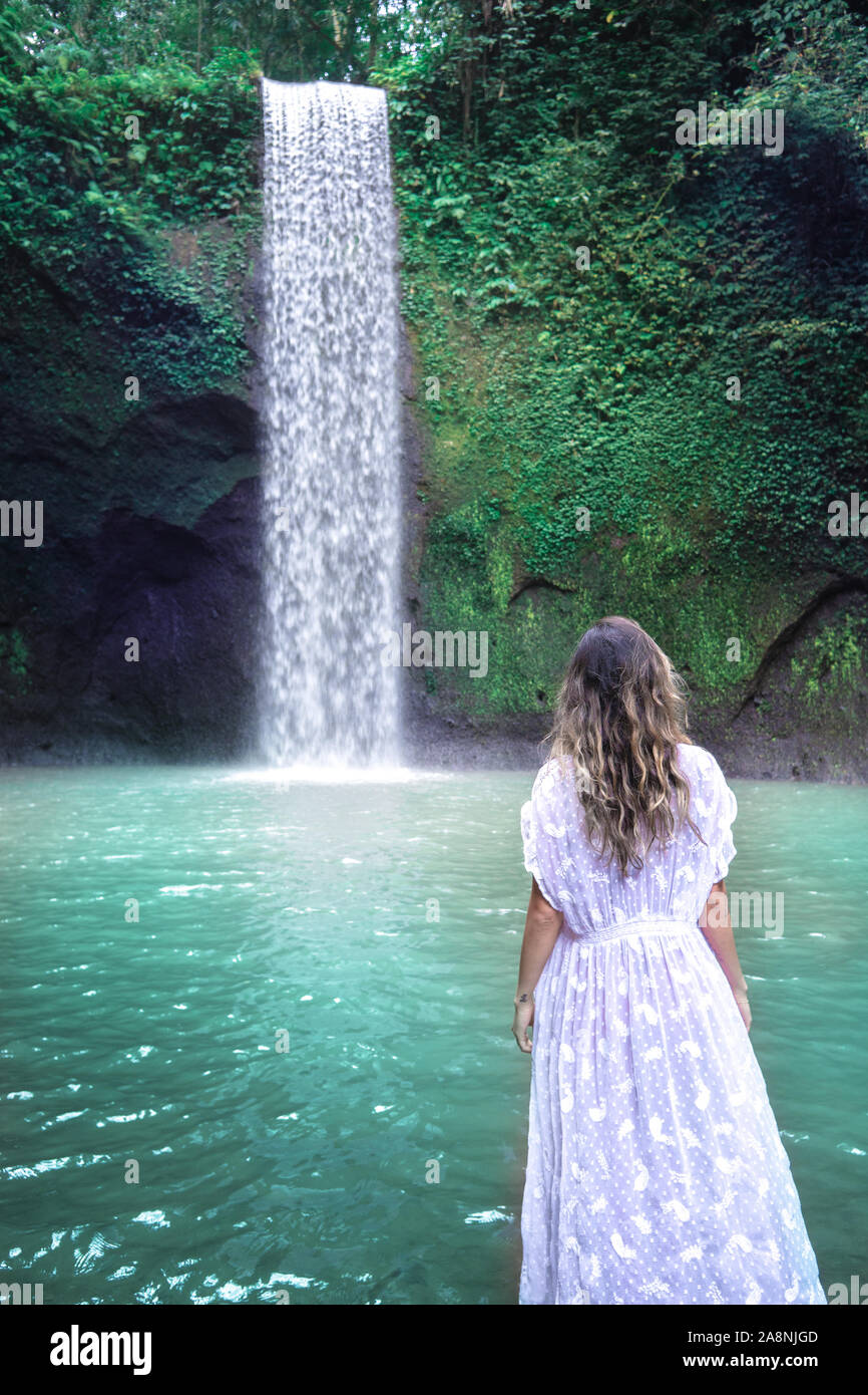 Young woman enjoying the view of a waterfall Stock Photo - Alamy