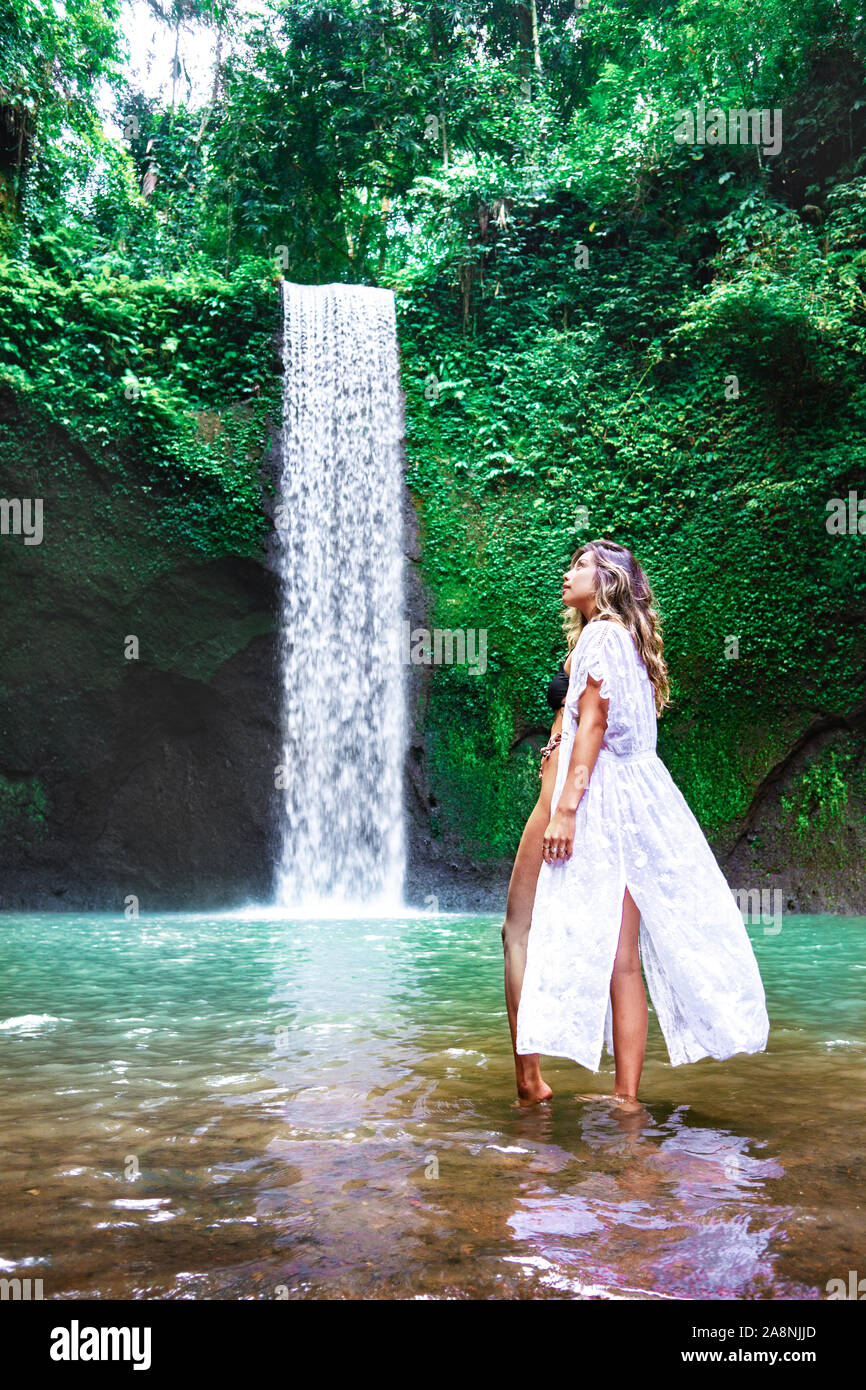 Young woman enjoying the view of a waterfall Stock Photo - Alamy