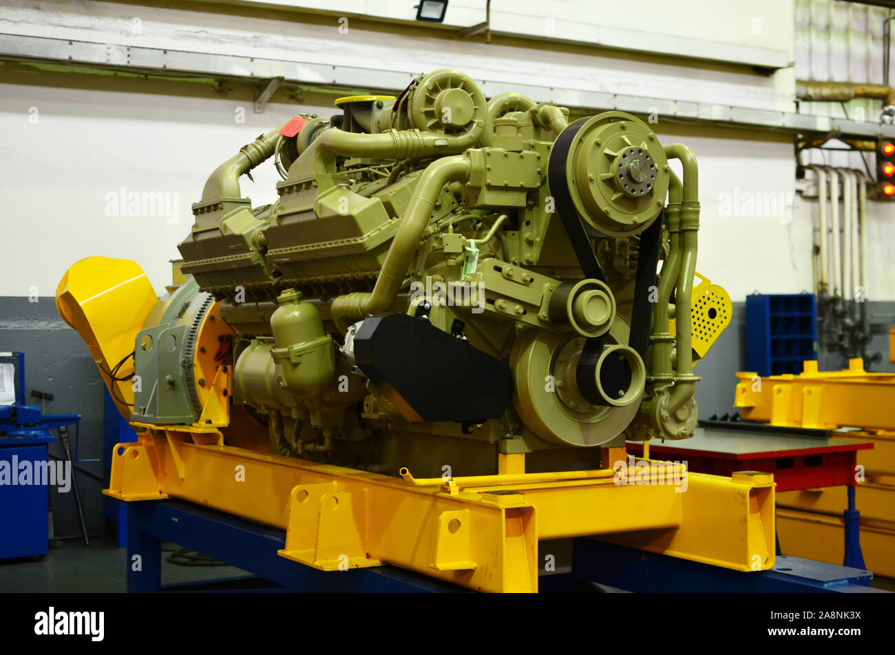 Large diesel engine with a huge turbine in the warehouse of finished ...