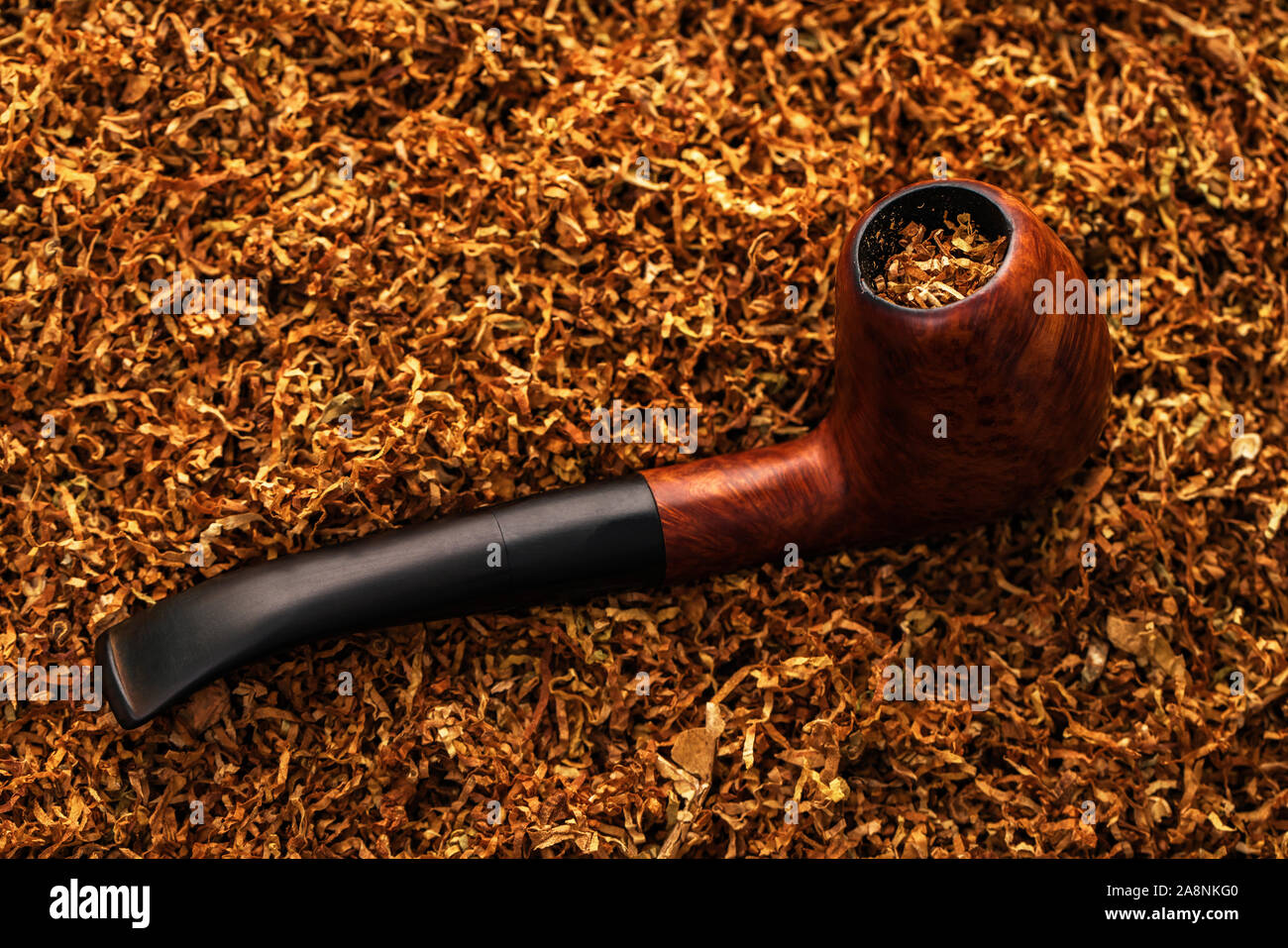 smoking pipe close-up on a background of dry tobacco Stock Photo - Alamy