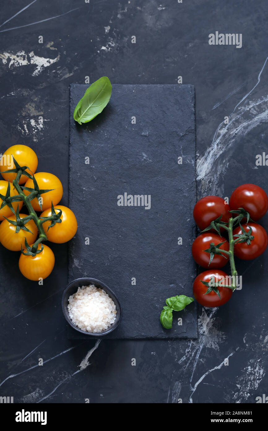 background for food menu, black graphite and tomatoes Stock Photo - Alamy