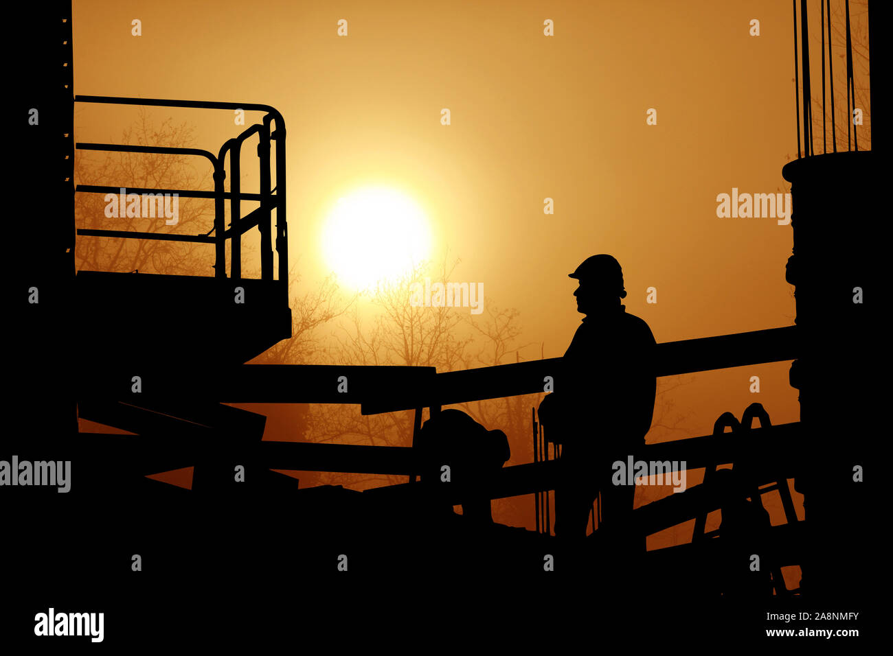 men at work in incredible sunset Stock Photo - Alamy