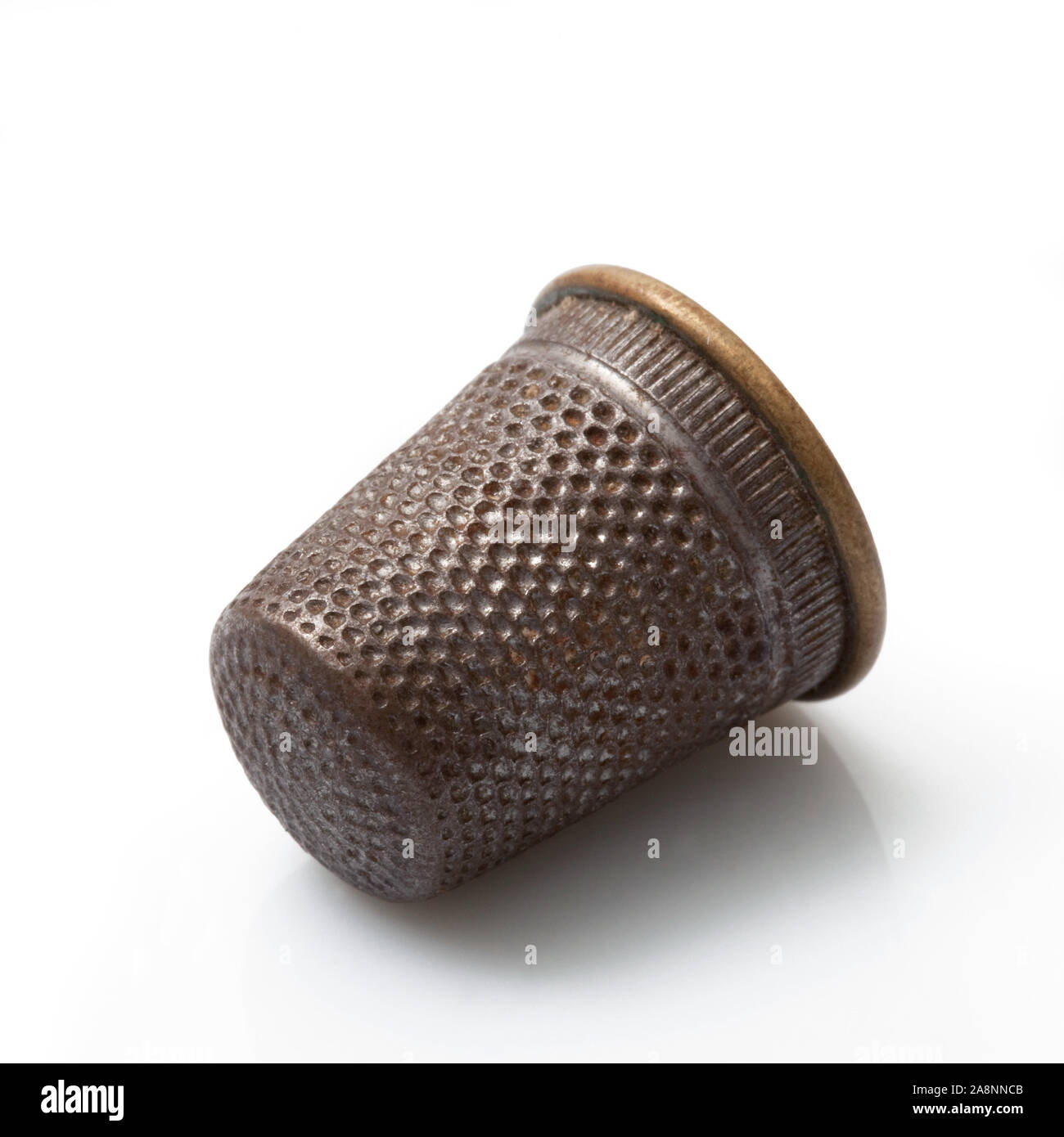 old thimble for seamstress on white background Stock Photo - Alamy