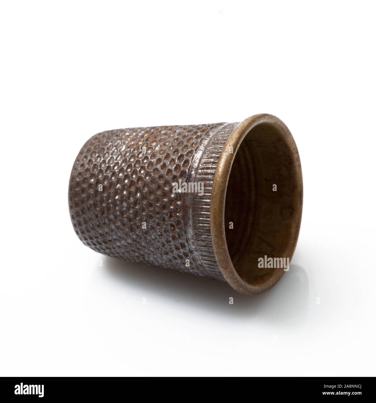 old thimble for seamstress on white background Stock Photo - Alamy
