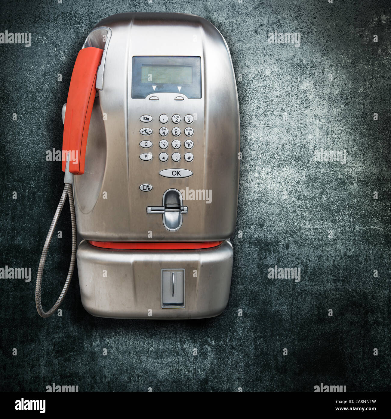old public phone on dark background Stock Photo - Alamy