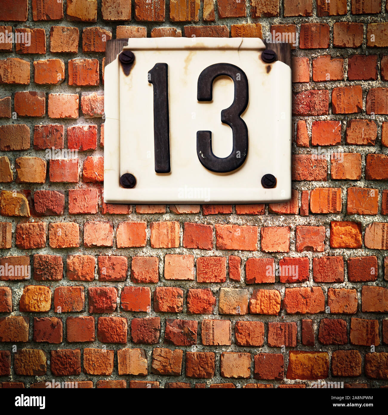 Number 13 on a wall background Stock Photo - Alamy