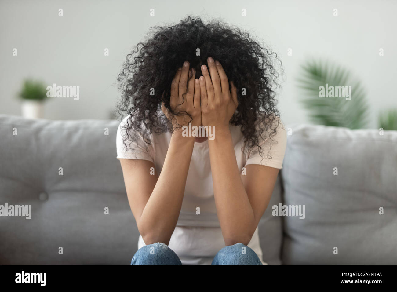 Unhappy African American woman holding head in hands, crying Stock ...