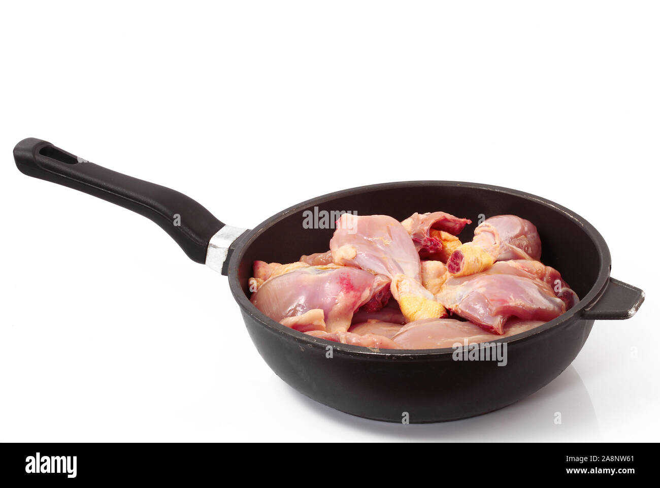 raw chicken in pot on white background Stock Photo - Alamy