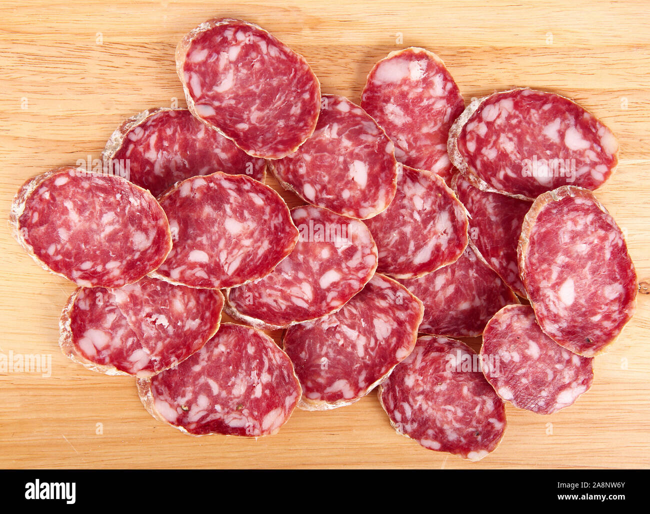 italian salami slice on chopping board background Stock Photo - Alamy