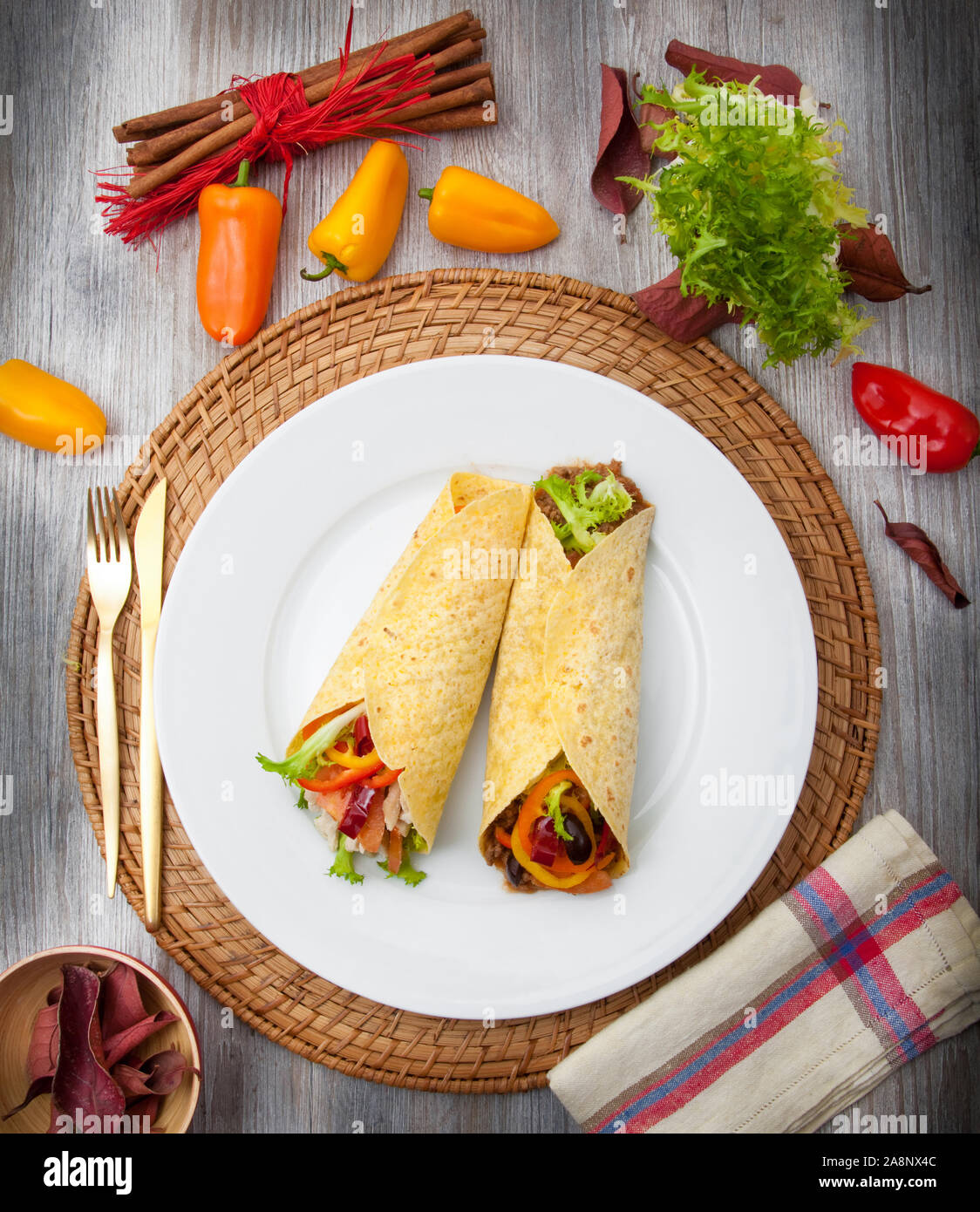original mexican burritos on white dish Stock Photo - Alamy