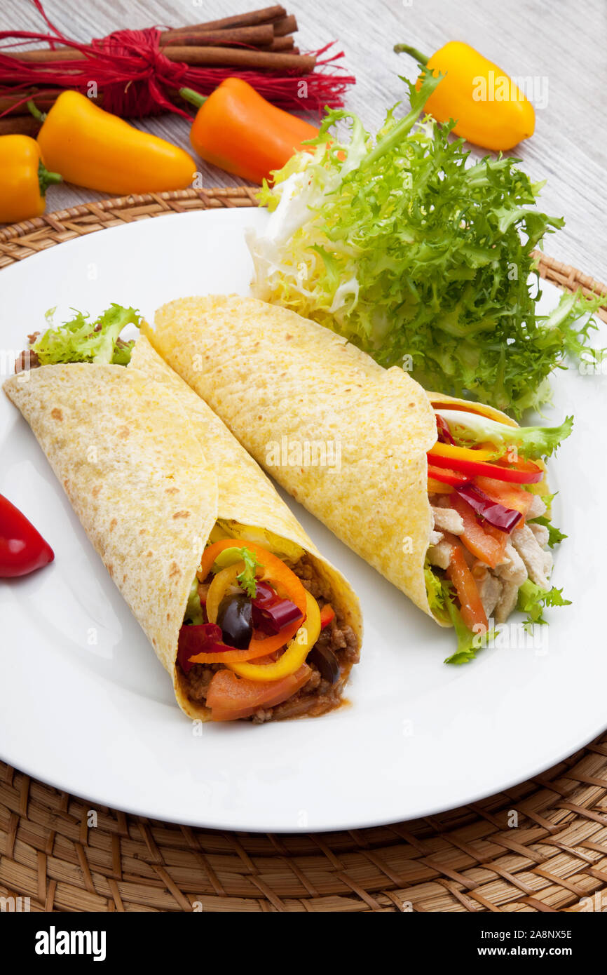 original mexican burritos on white dish Stock Photo - Alamy