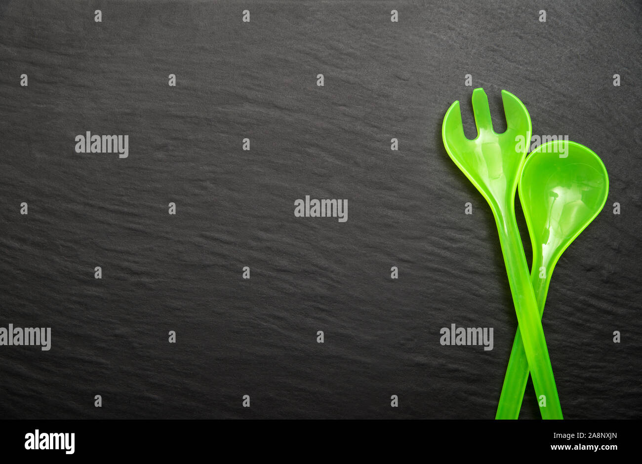 green spoon on black background Stock Photo - Alamy