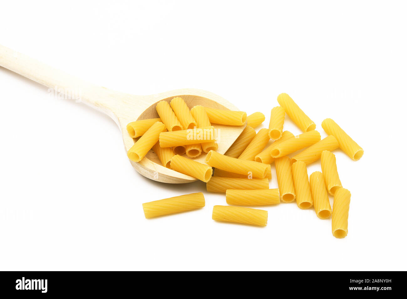 wood spoon with italian raw pasta on white background Stock Photo - Alamy