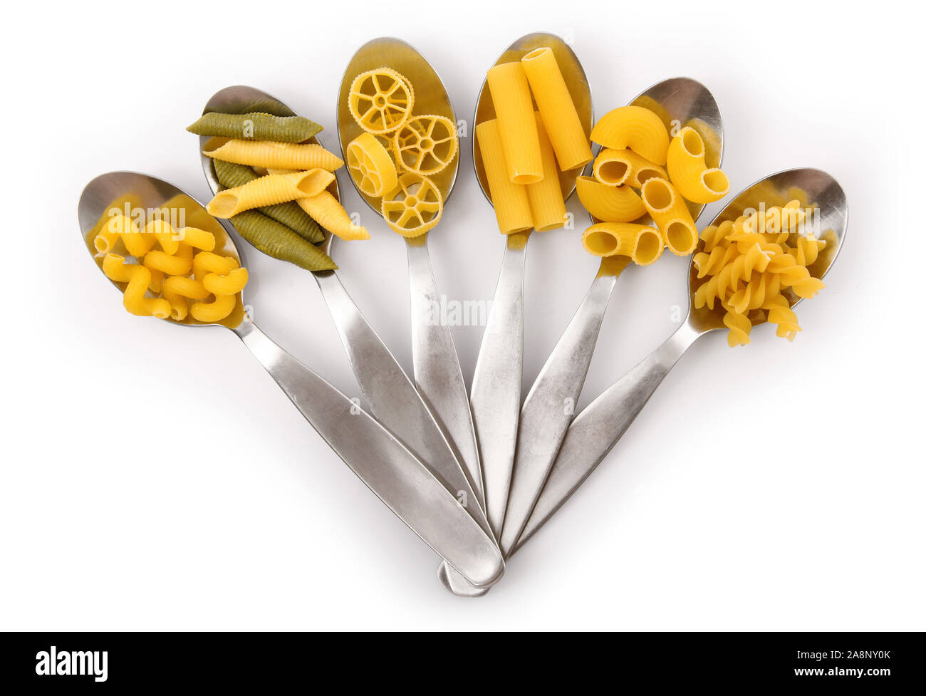 spoons with italian raw pasta on white background Stock Photo - Alamy