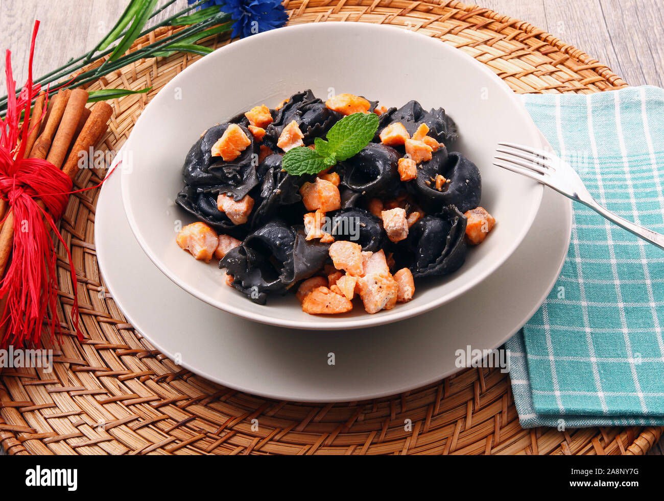 black ravioli at squid ink with salmon Stock Photo - Alamy