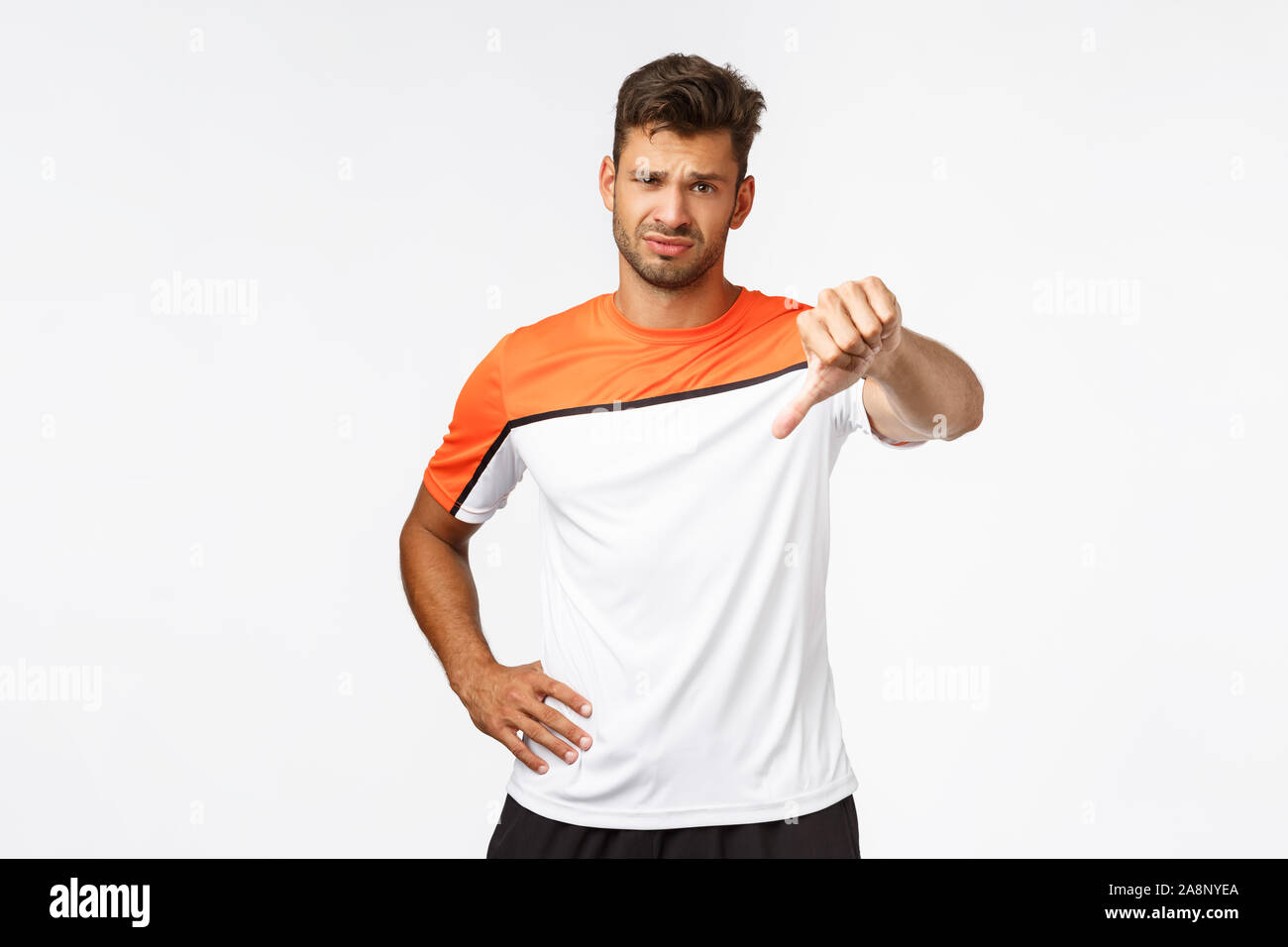 Disappointed handsome sportsman, football player displeased of someone ...