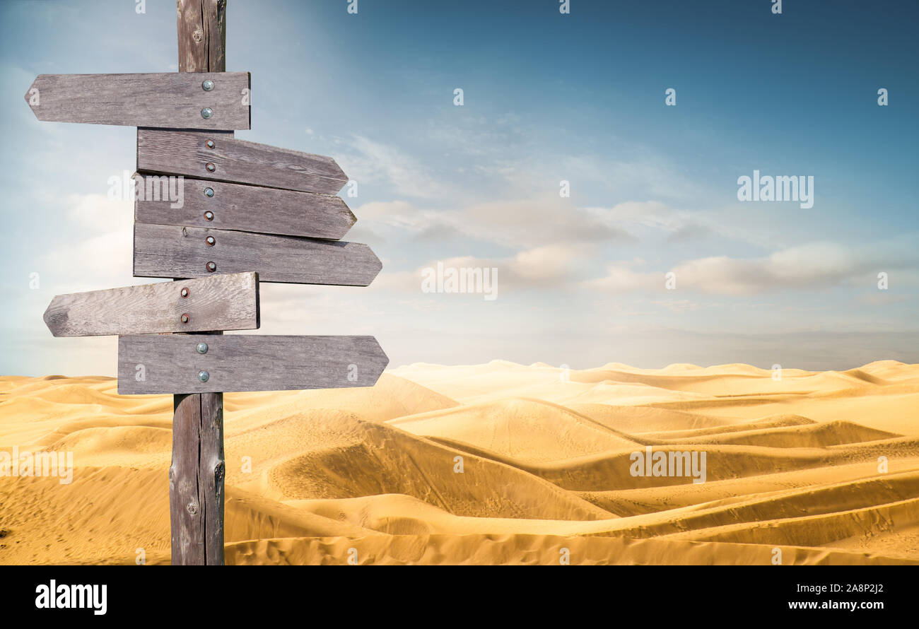 direction wooden arrows in the desert Stock Photo - Alamy