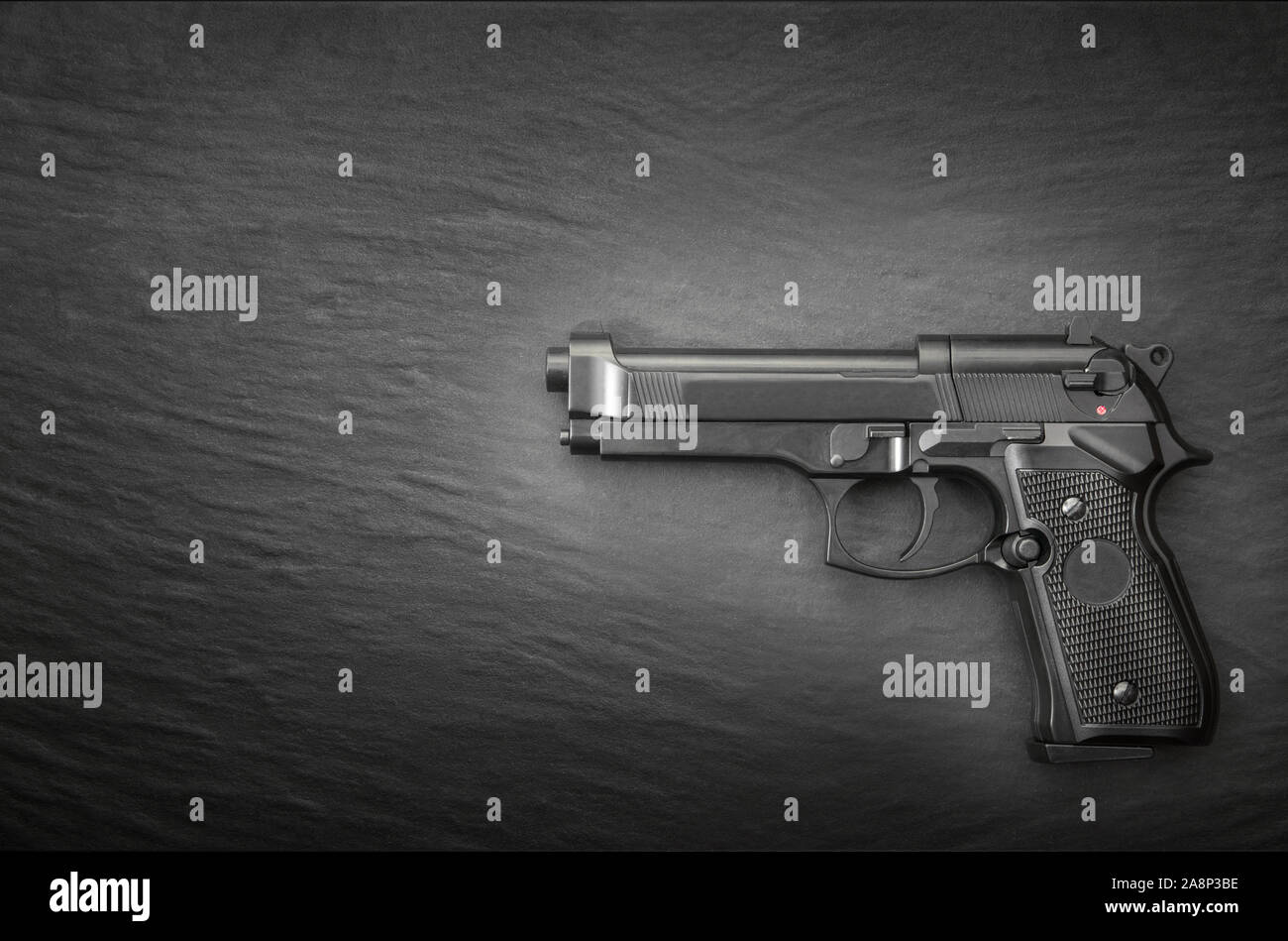 black gun on dark background Stock Photo - Alamy
