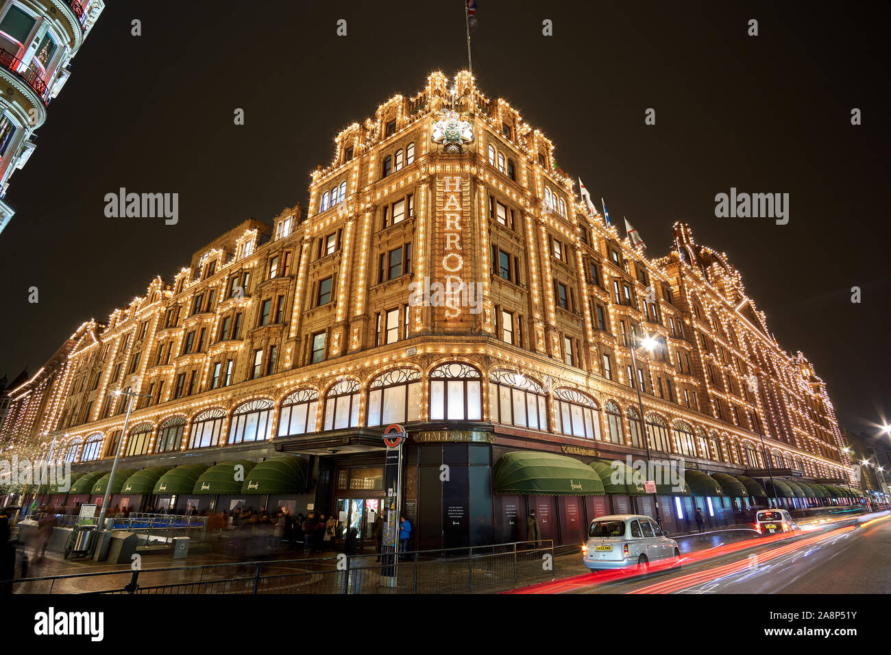 Exterior view of Harrods Department Store in London at night during ...