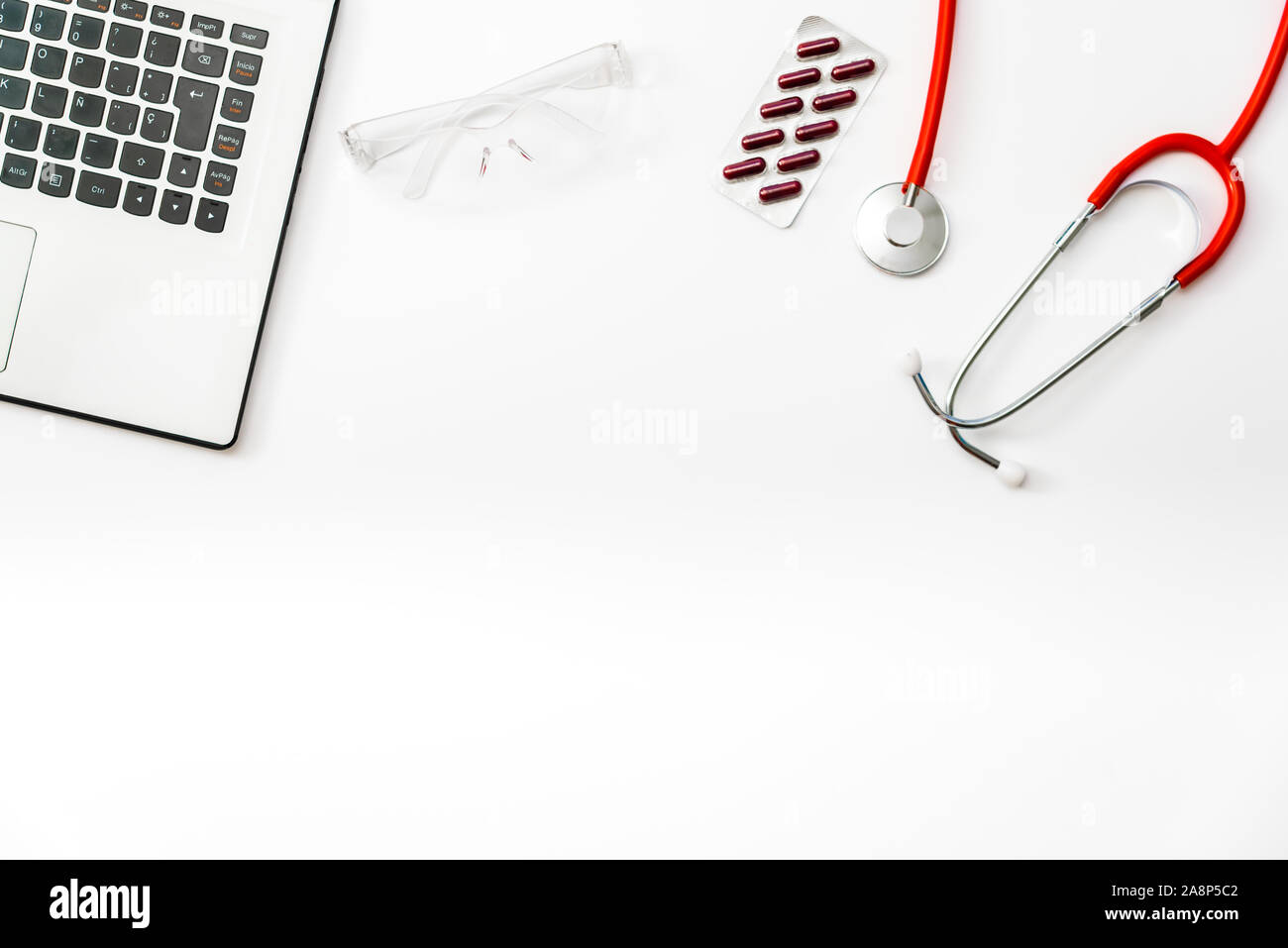 Top view doctors desk with stethoscope and laptop Stock Photo - Alamy