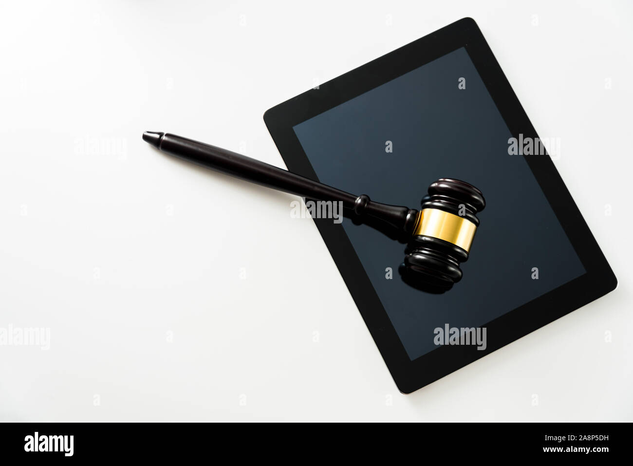 Gavel on a tablet computer isolated on white studio background, copy ...