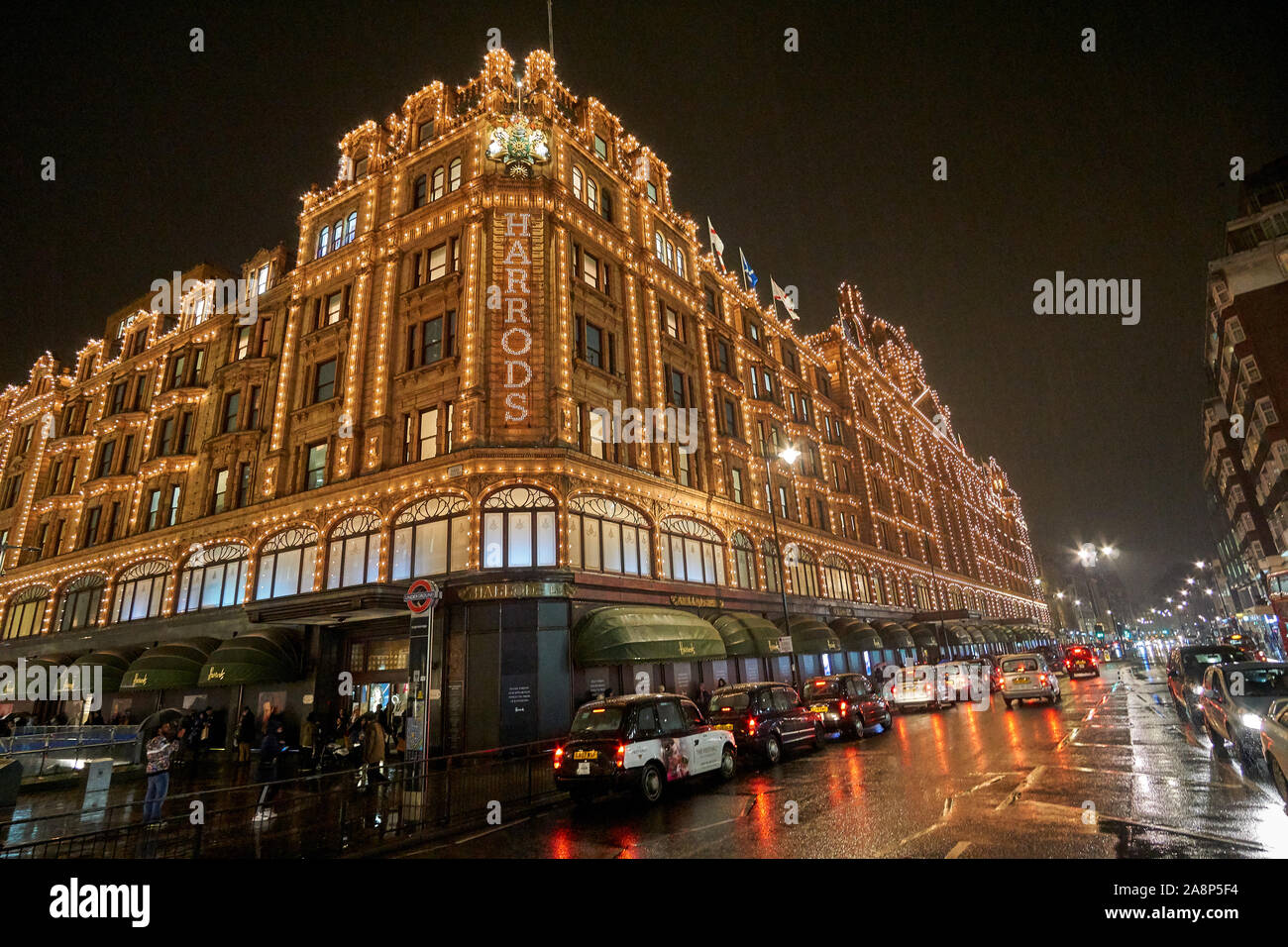 Exterior view of Harrods Department Store in London at night during ...