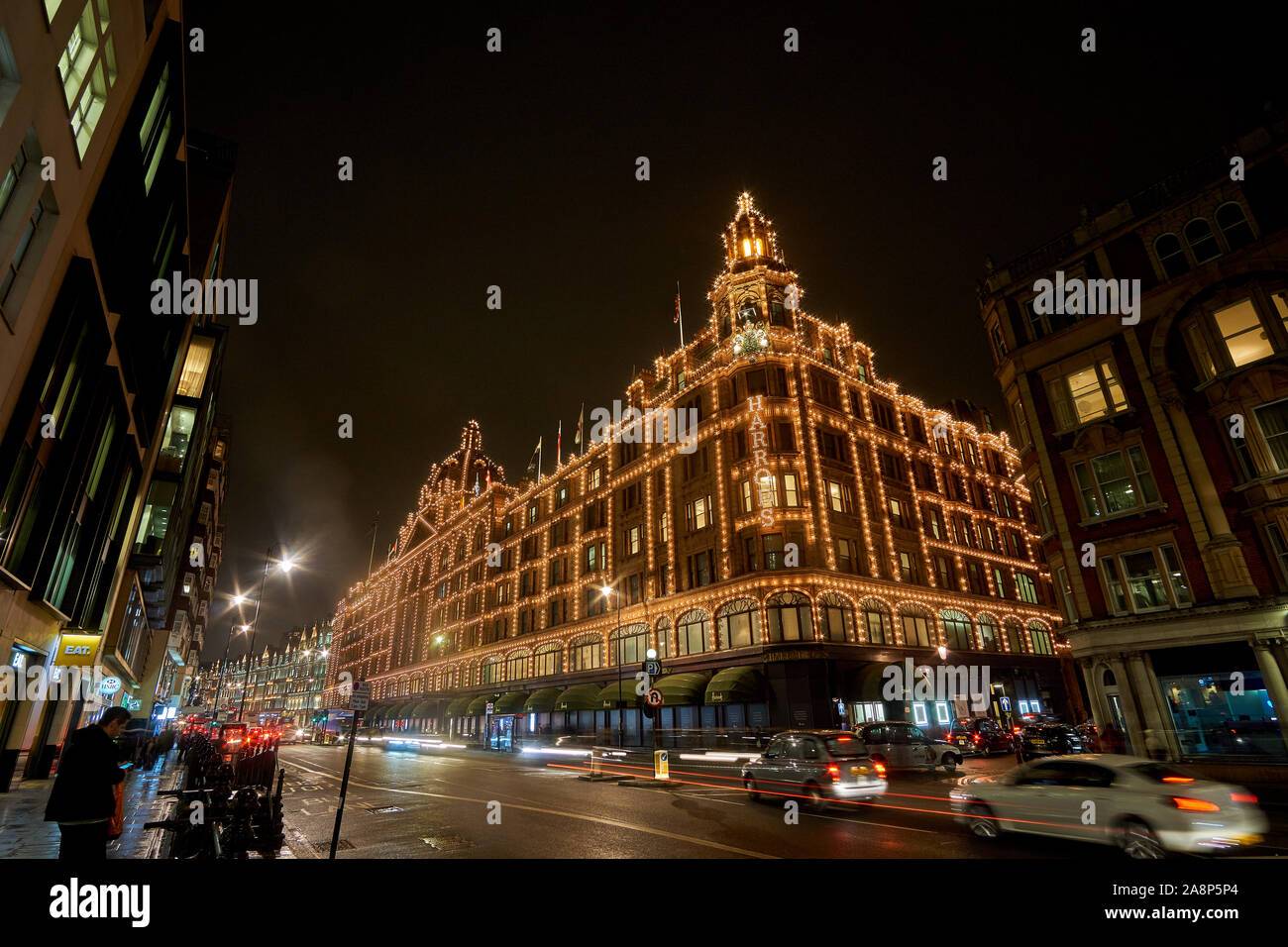 Exterior view of Harrods Department Store in London at night during ...