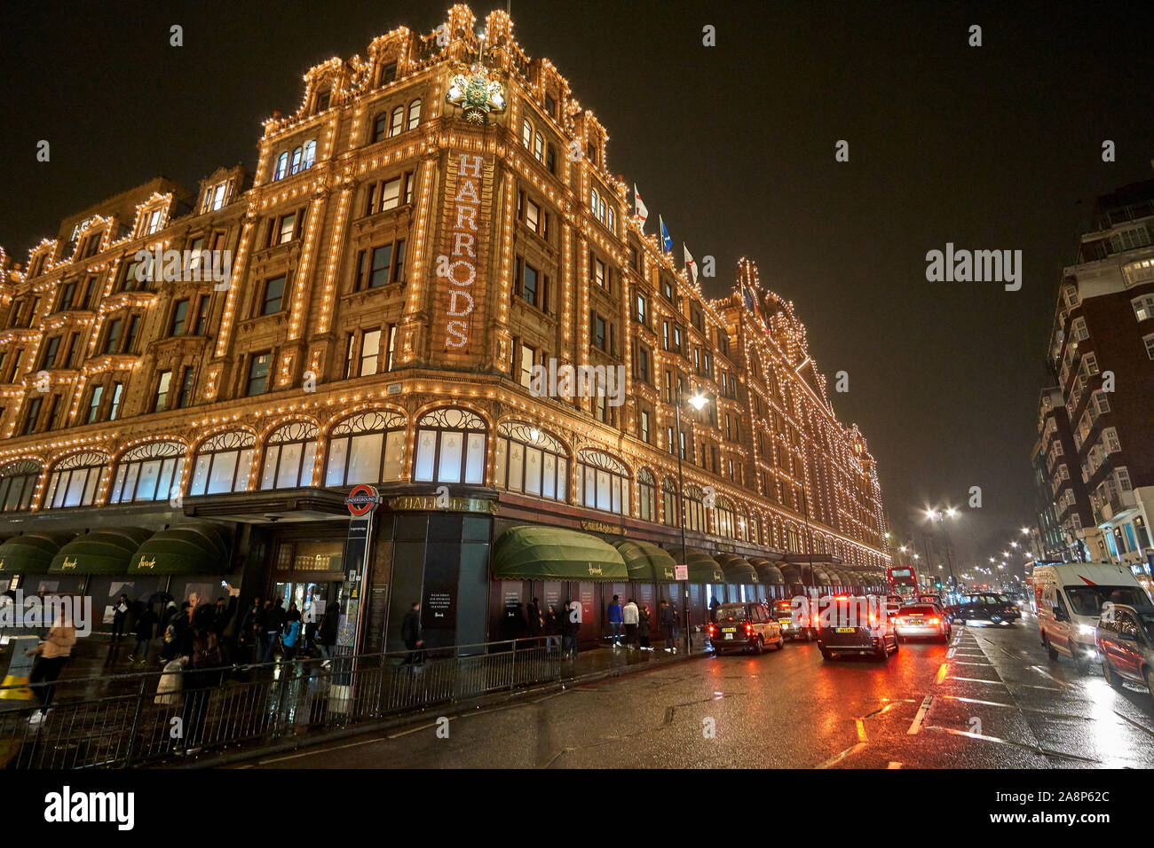 Exterior view of Harrods Department Store in London at night during ...