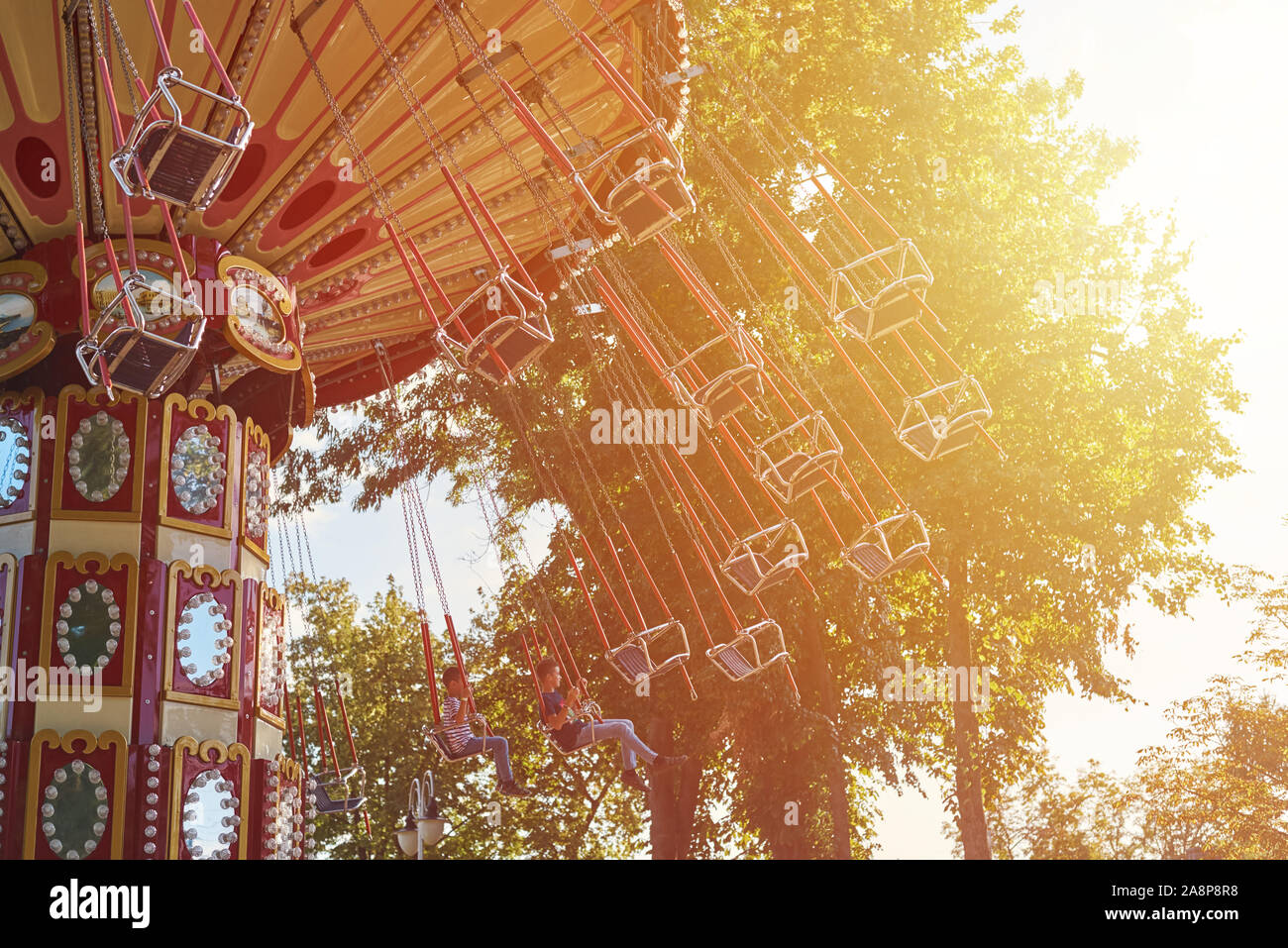 Chain carousel merry-go-round in amusement park Stock Photo - Alamy
