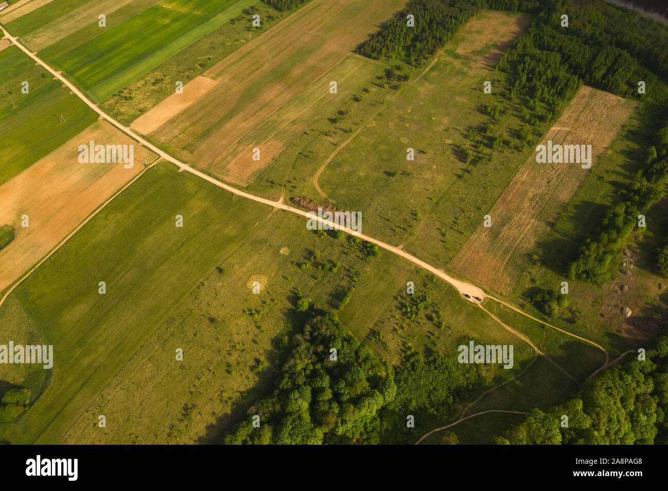 Drone view of agricultural meadow with single road through it Stock ...