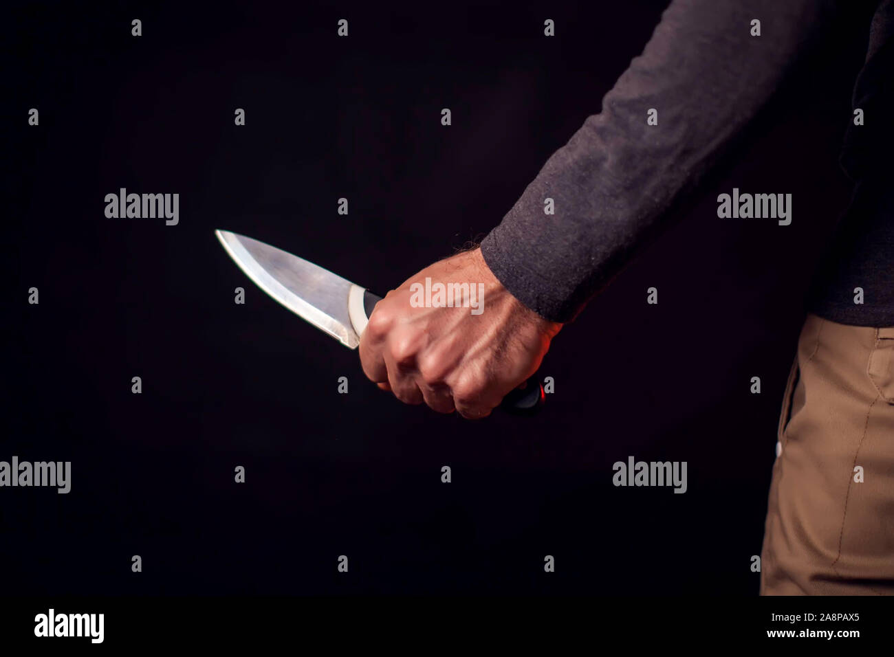 Man holds knife. People, family violence, crime concept Stock Photo - Alamy