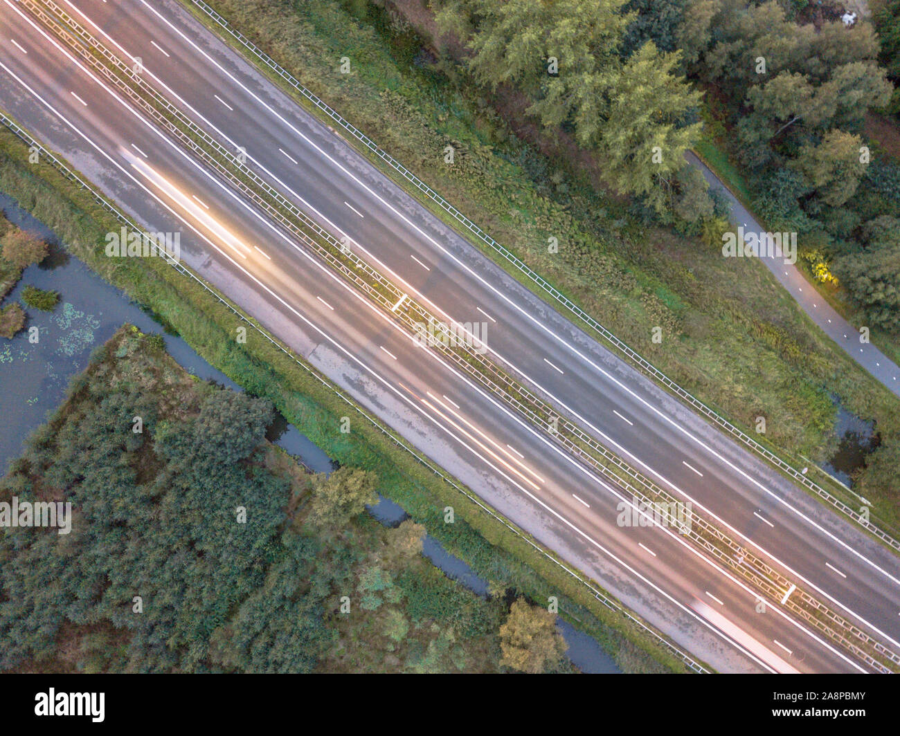 Aerial view of four lane motorway with emergency lane and moderate ...