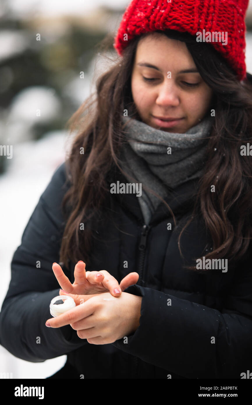 woman using cream at cold winter weather. skin protection Stock Photo ...