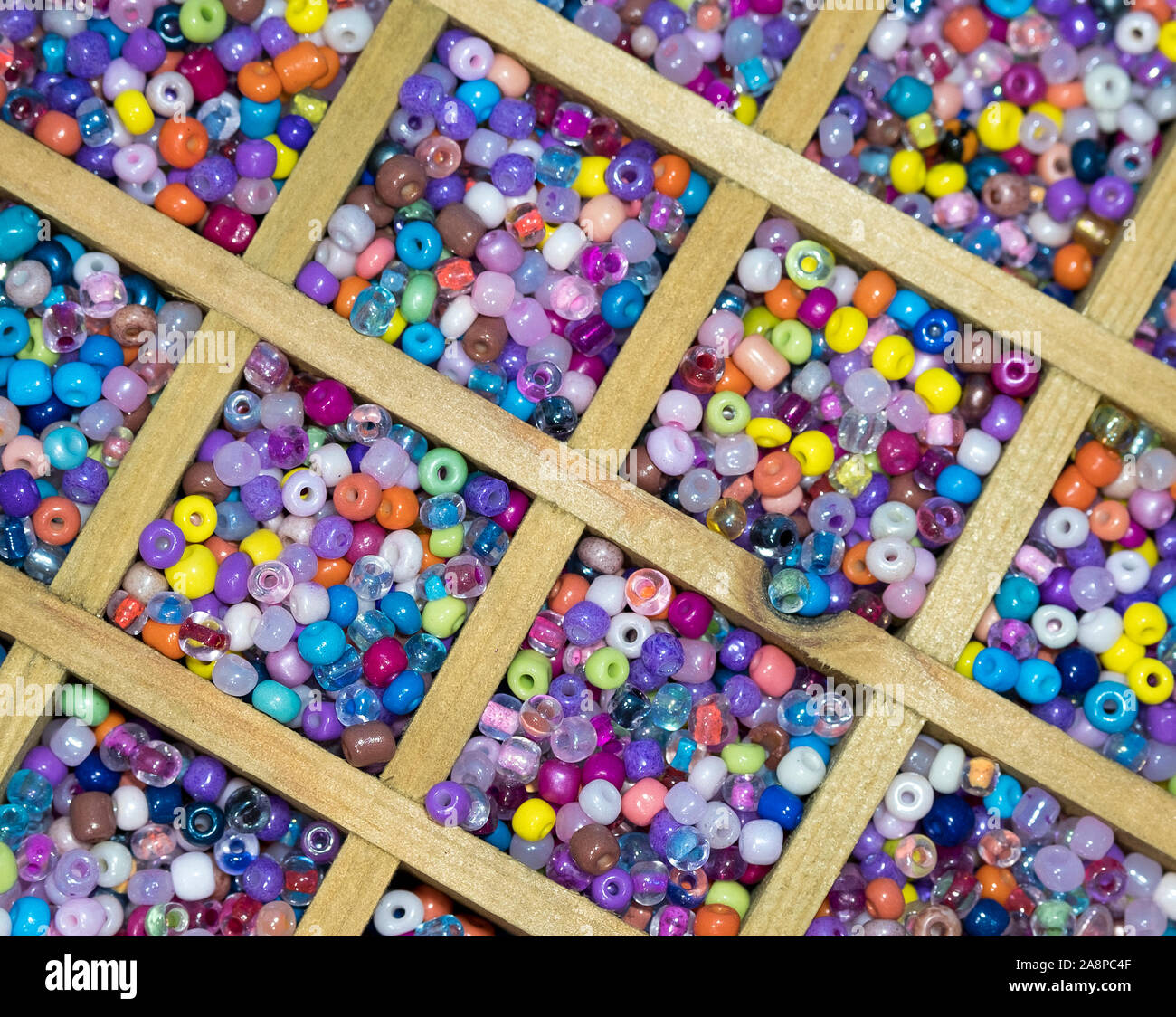 Coloured micro beads in boxes Stock Photo - Alamy