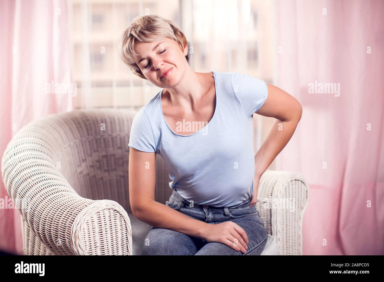 Woman feels back pain. People, healthcare and medicine concept Stock ...