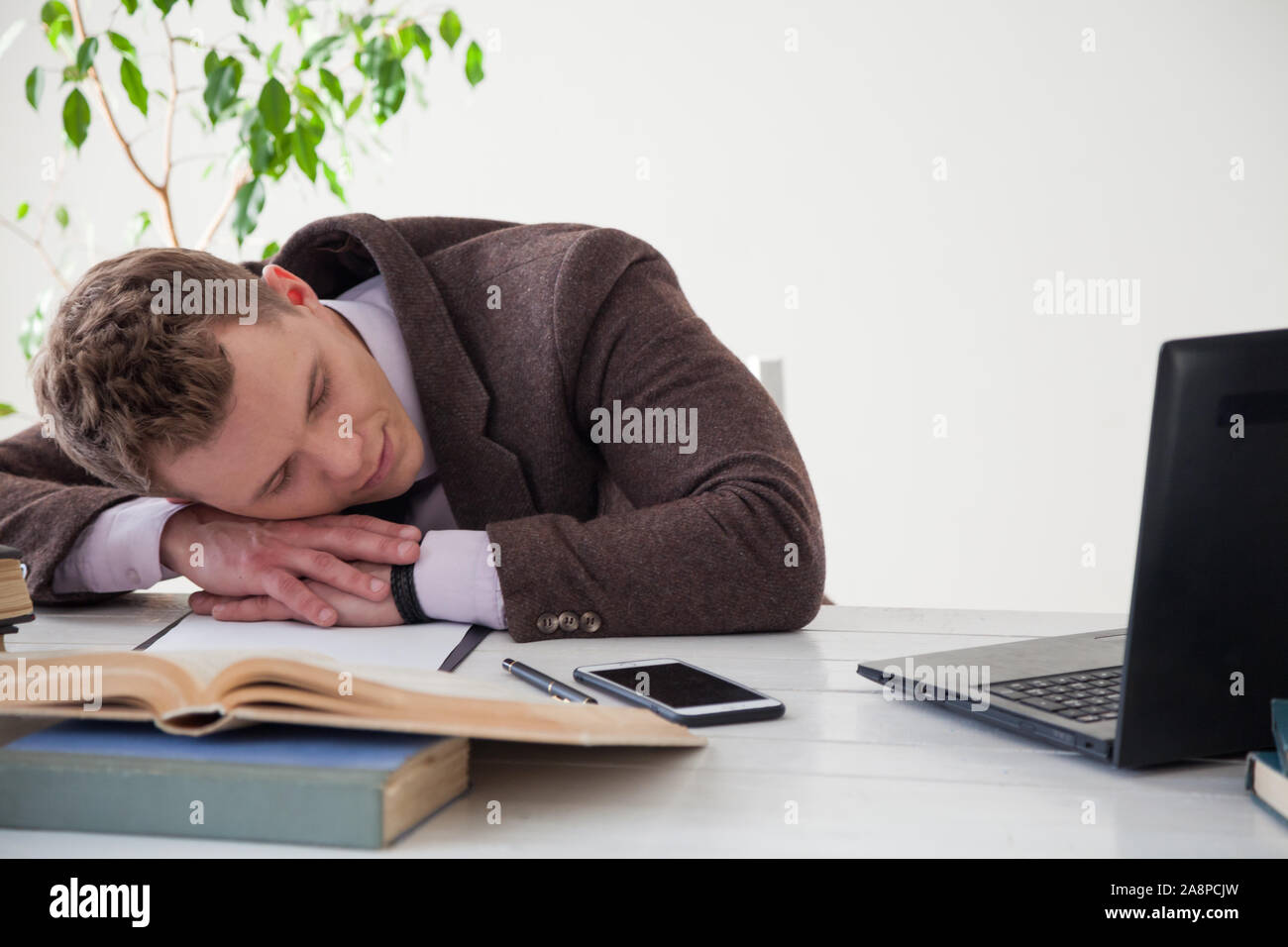 portrait of a handsome business man sleeping at work in the office ...
