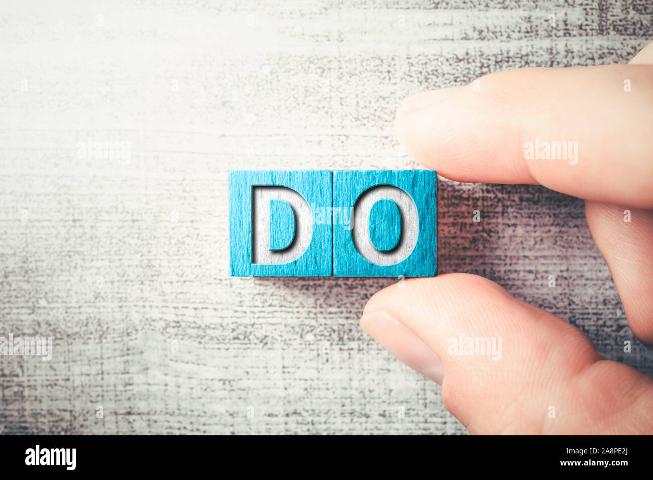 The Word DO On Wooden Blocks And Arranged By Two Male Fingers On A ...