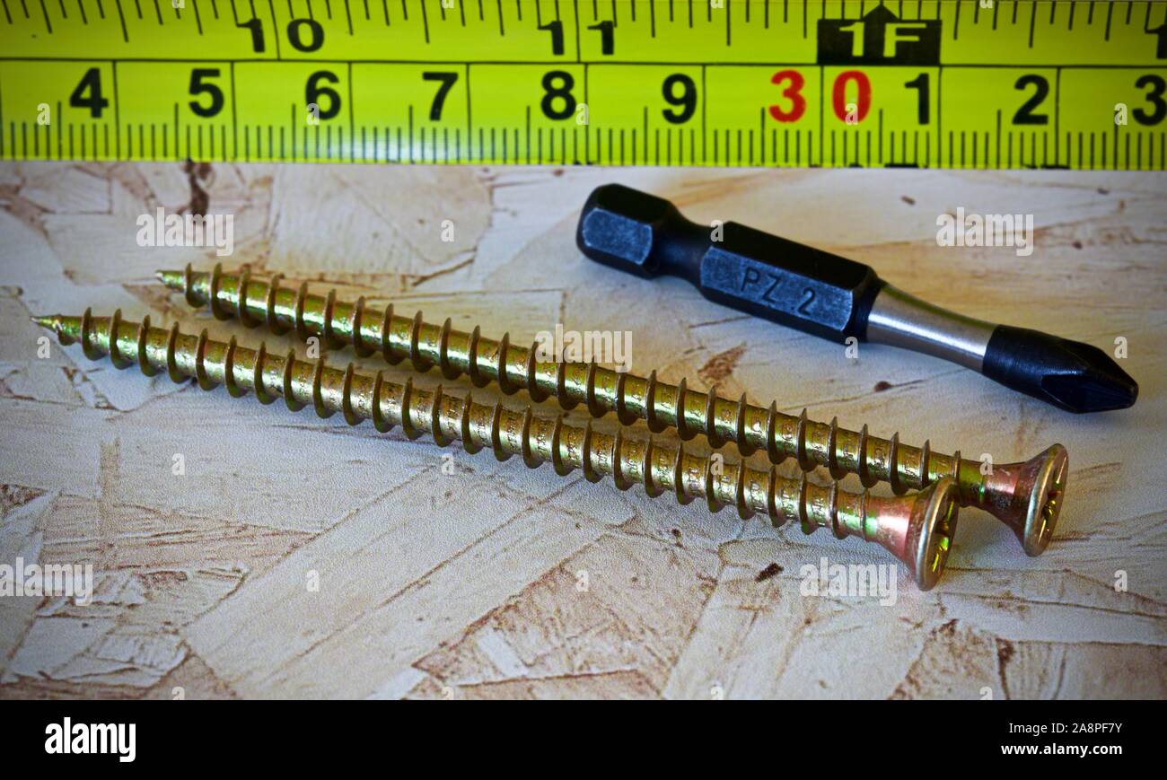 Tape measure and wood screws Stock Photo - Alamy