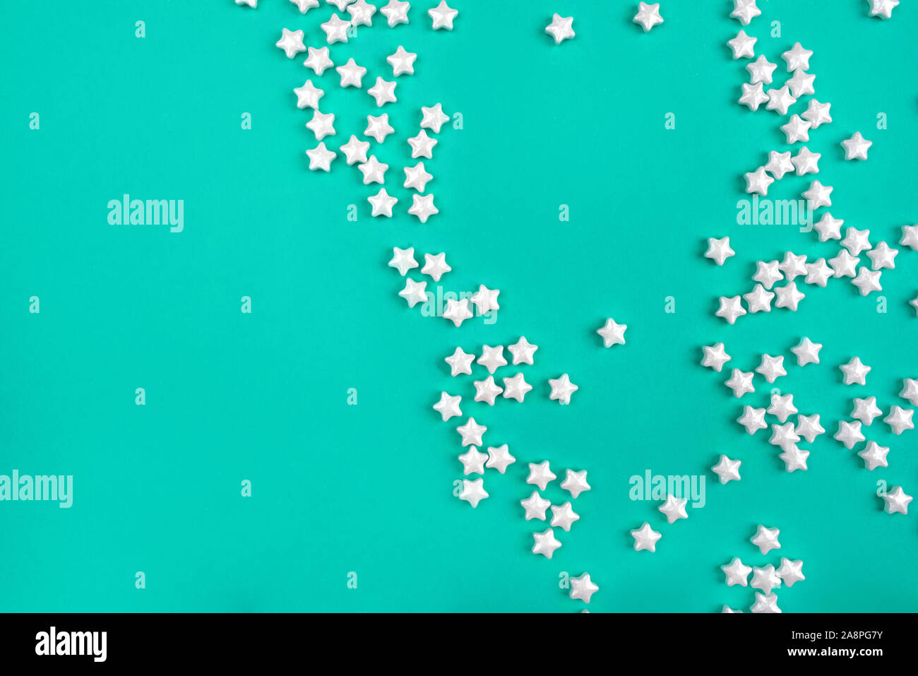 Little white stars on mint background Stock Photo - Alamy