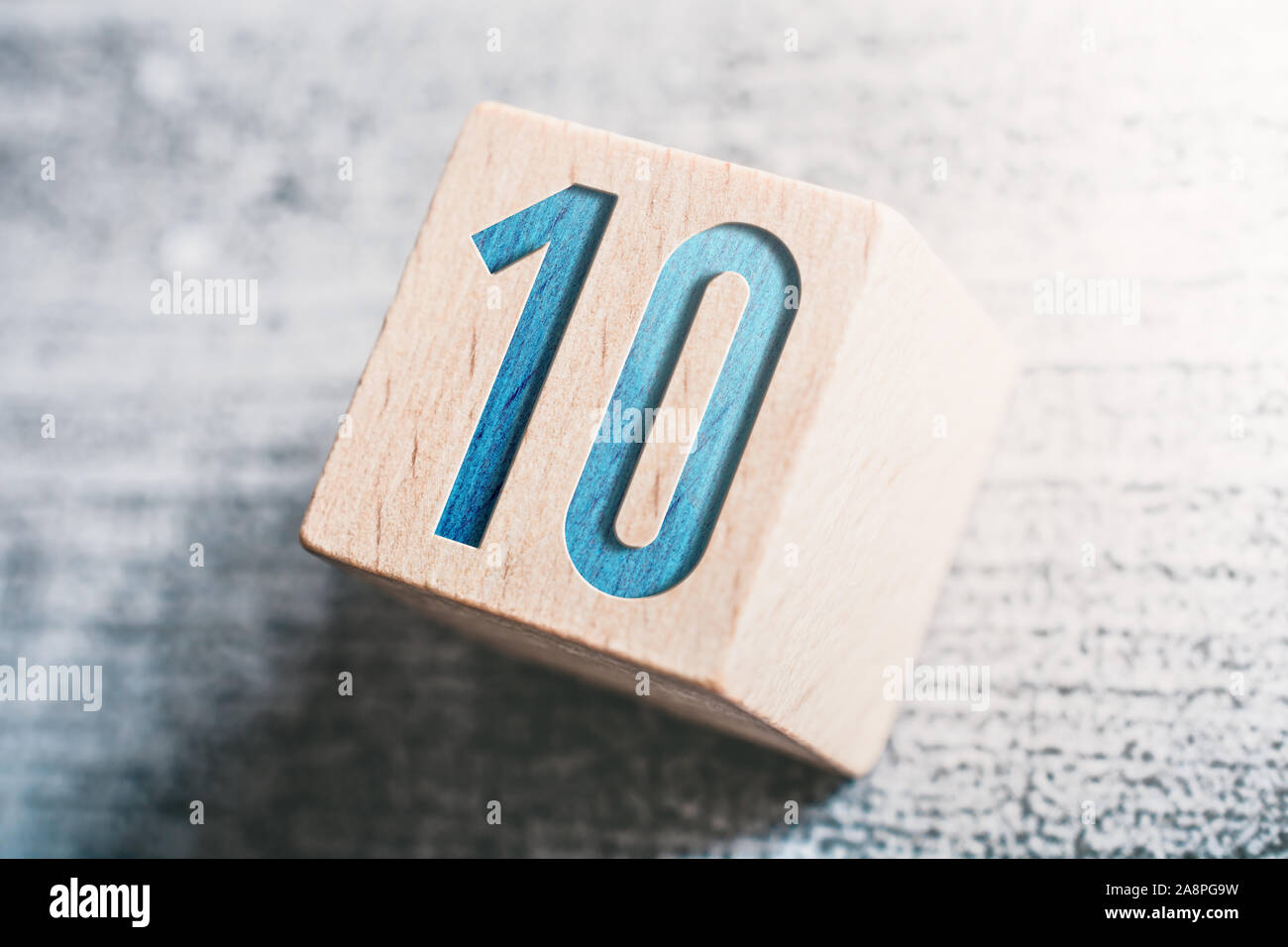 The Number 10 On A Wooden Block On A Table Stock Photo - Alamy